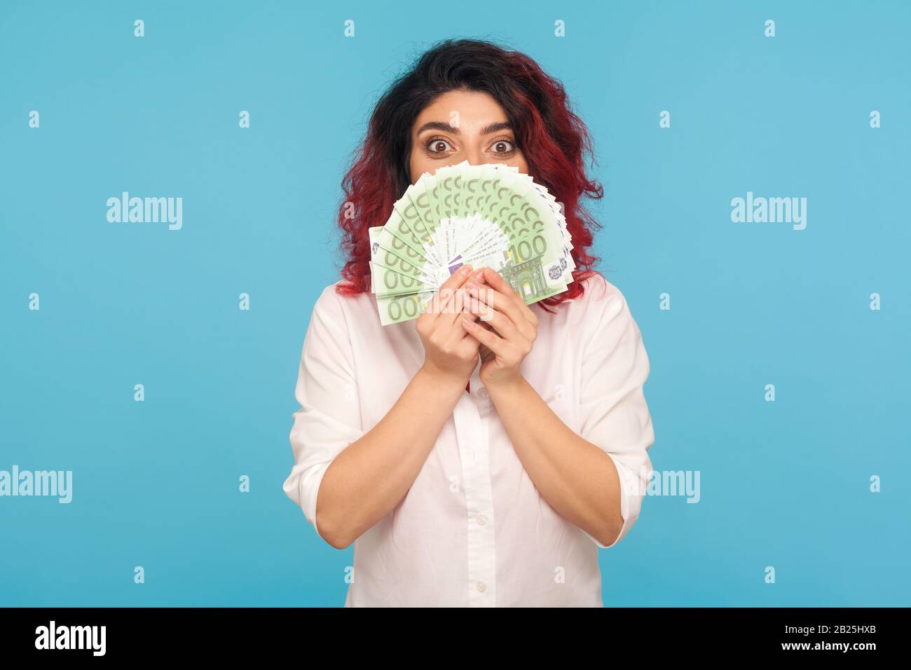 Portrait of surprised woman entrepreneur hiding behind money, covering ...