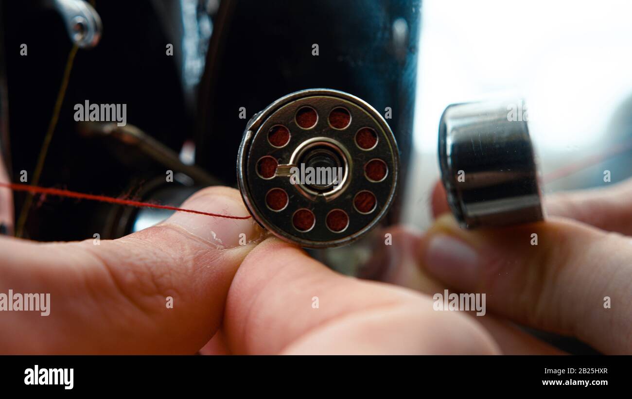 Tailor or woman who returns a bottom thread and bobbin Case. Sewing ...