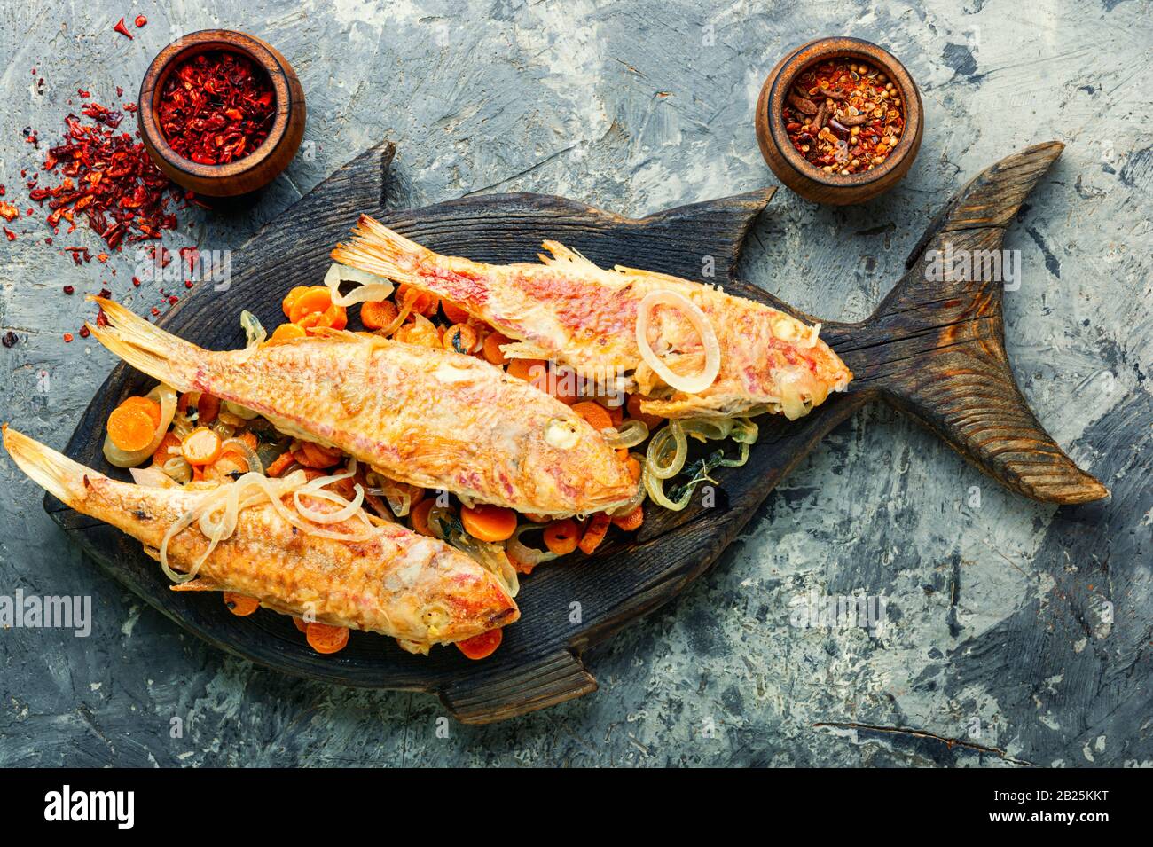 Mullet fish fried with horseradish roots.Tasty and spicy fry fish Stock ...
