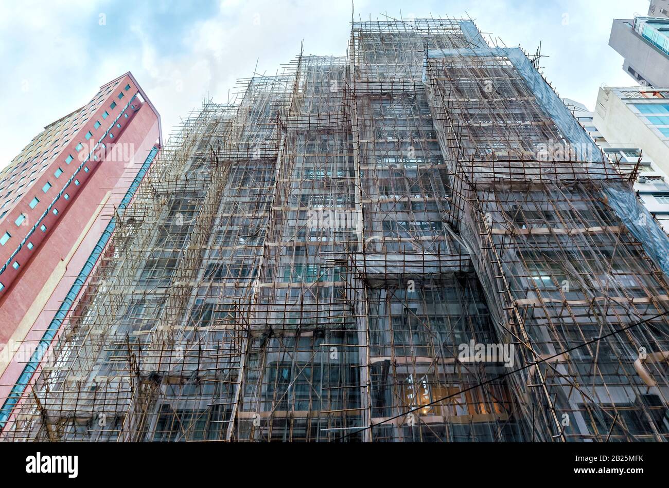 Renovation of building facade with scaffolding. Construction of high ...
