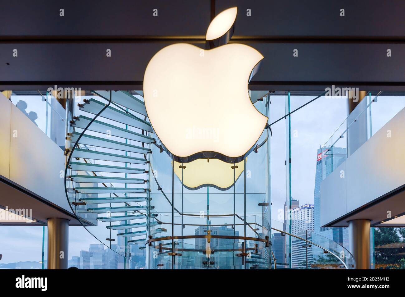 Apple store logo on a glass wall building. City skyscrapers in the ...