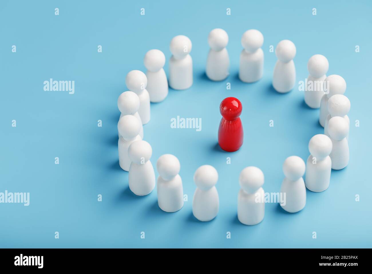 A team of white people stands around and listens to the leader of the ...