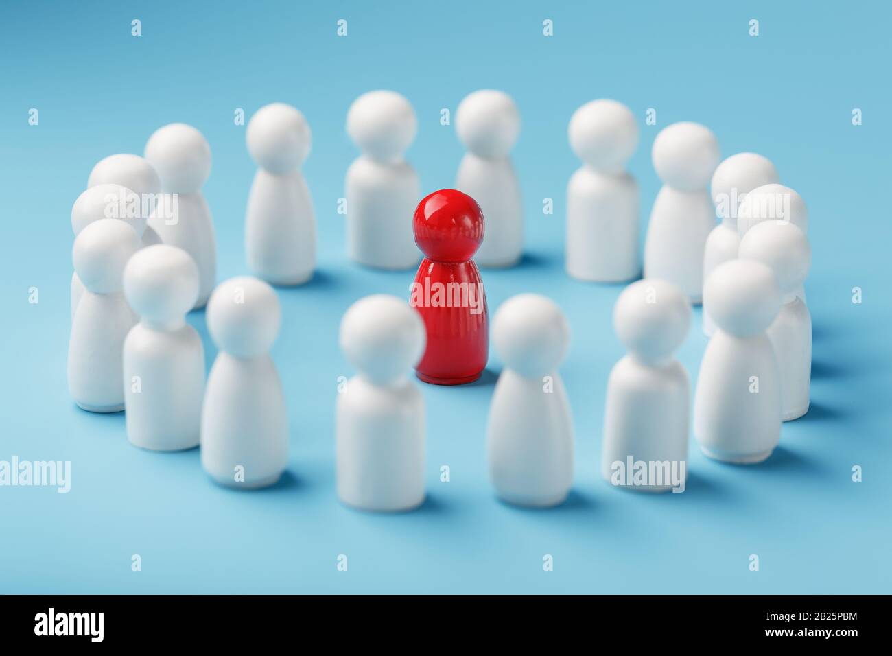 A team of white people stands around and listens to the leader of the ...