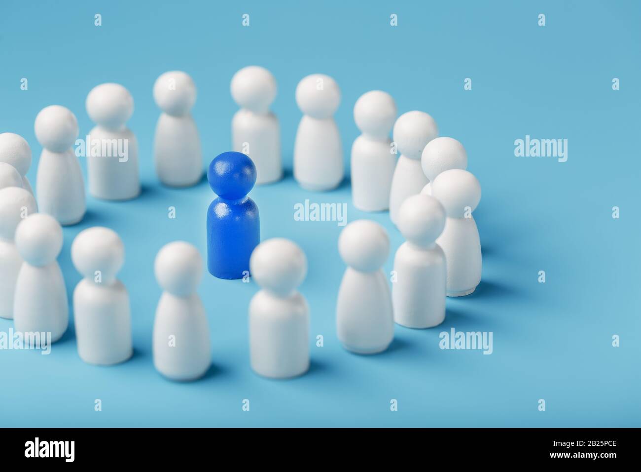 A team of white people stands around and listens to the leader's blue ...