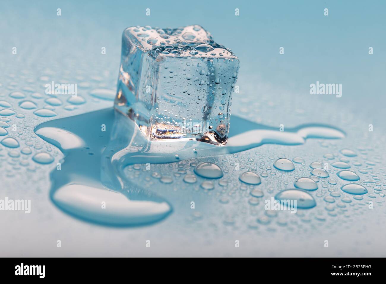 Ice cube with water drops on a blue background. The ice is melting. Refreshing ice Stock Photo ...