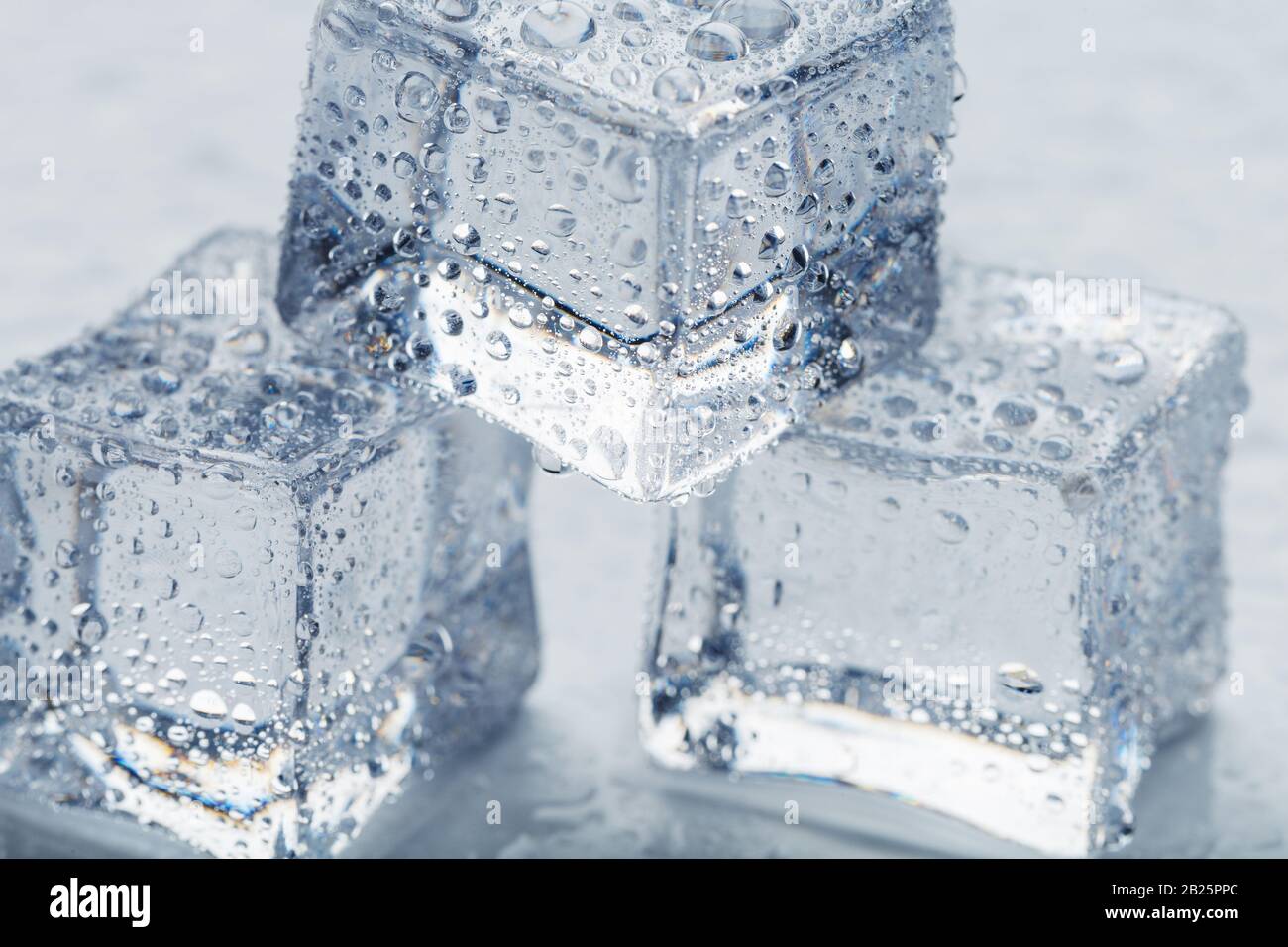 Ice cubes in the form of a pyramid with water drops close - up in macro ...