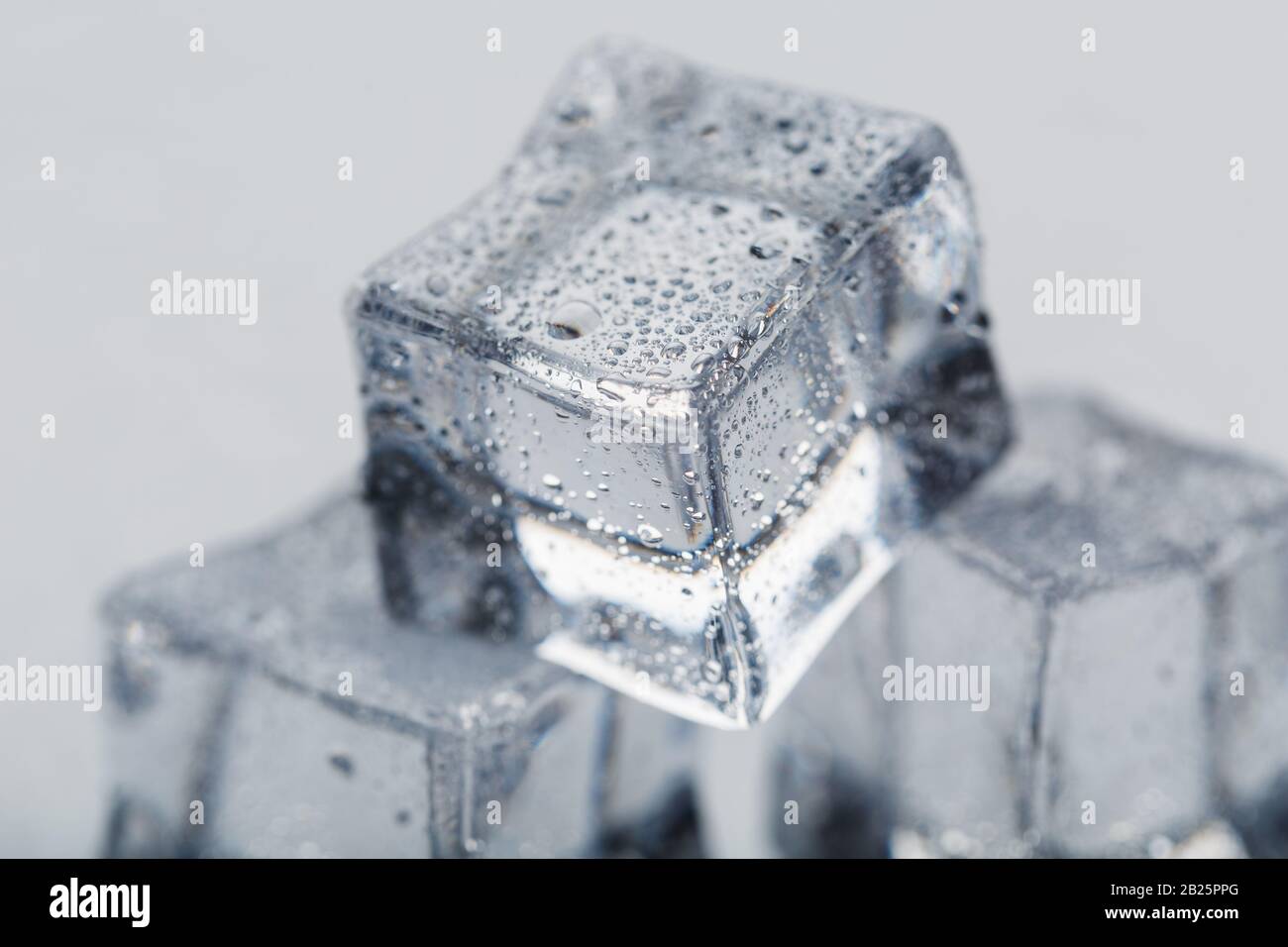 Ice cubes in the form of a pyramid with water drops close - up in macro ...