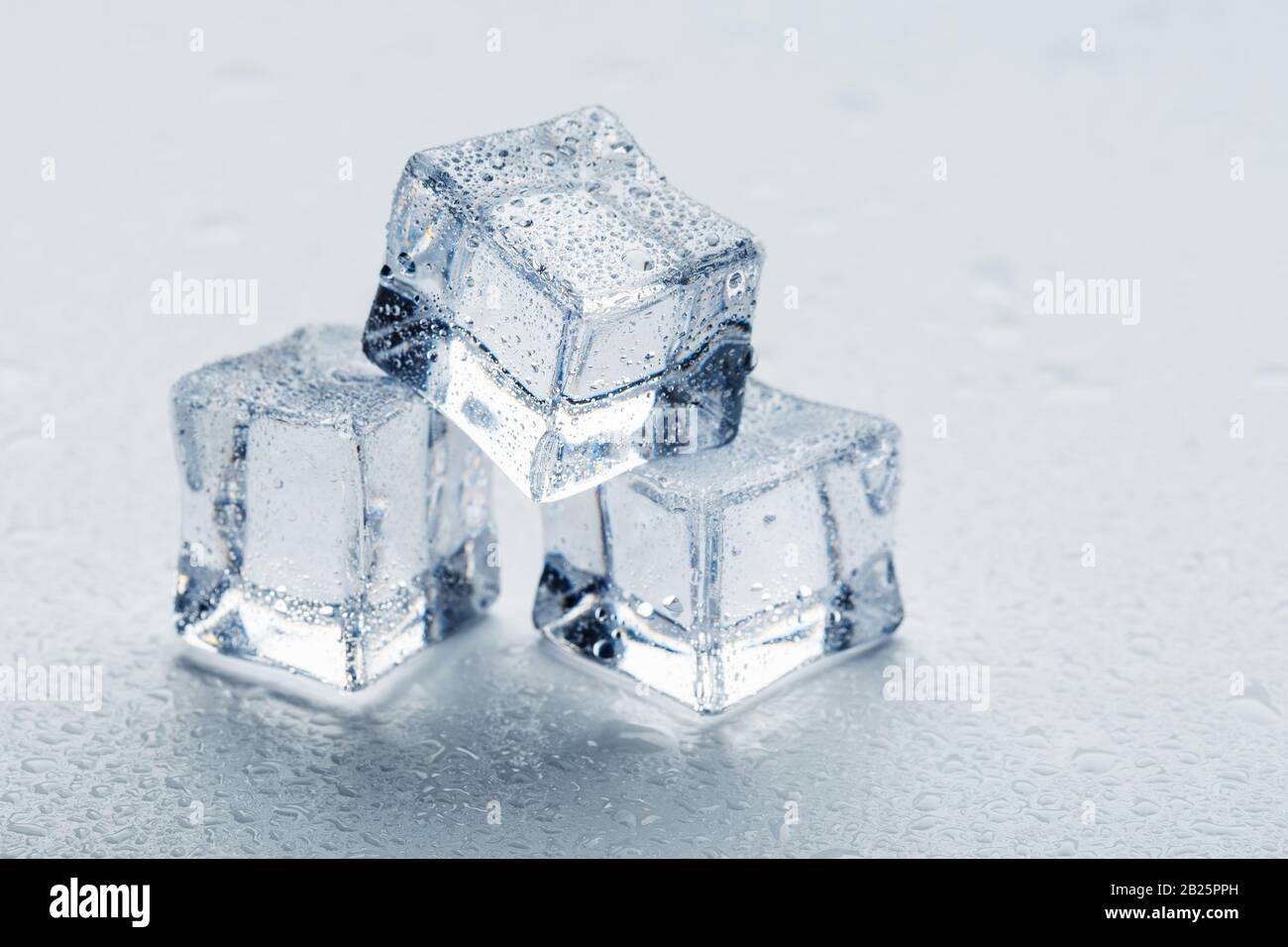 Ice cubes in the form of a pyramid with water drops close - up in macro ...