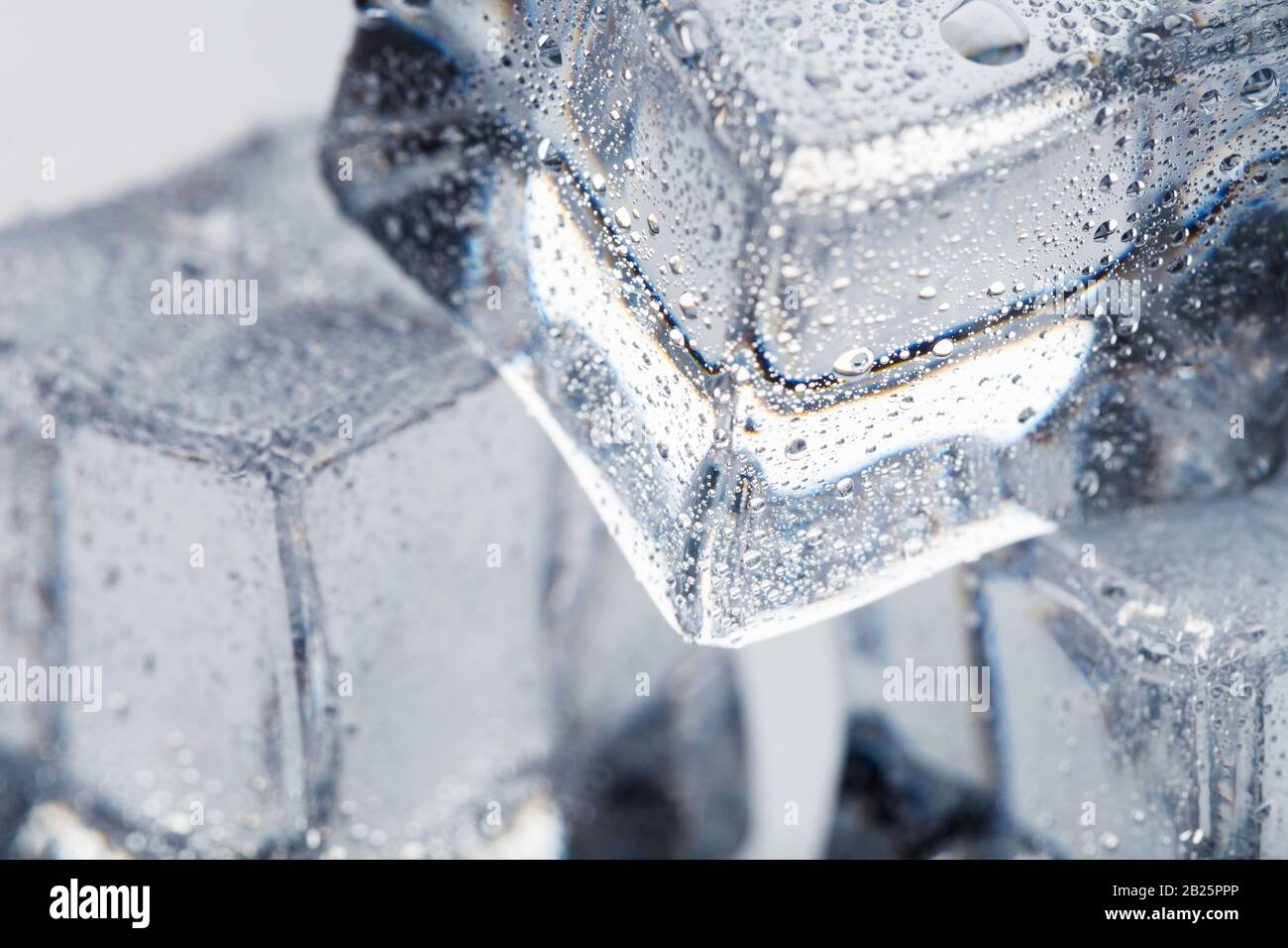 Ice cubes in the form of a pyramid with water drops close - up in macro ...