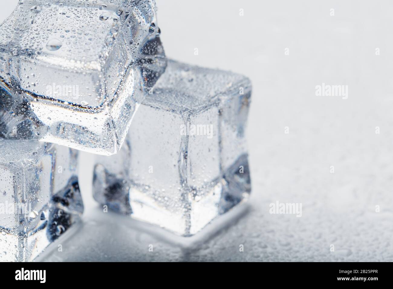 Ice cubes in the form of a pyramid with water drops close - up in macro ...