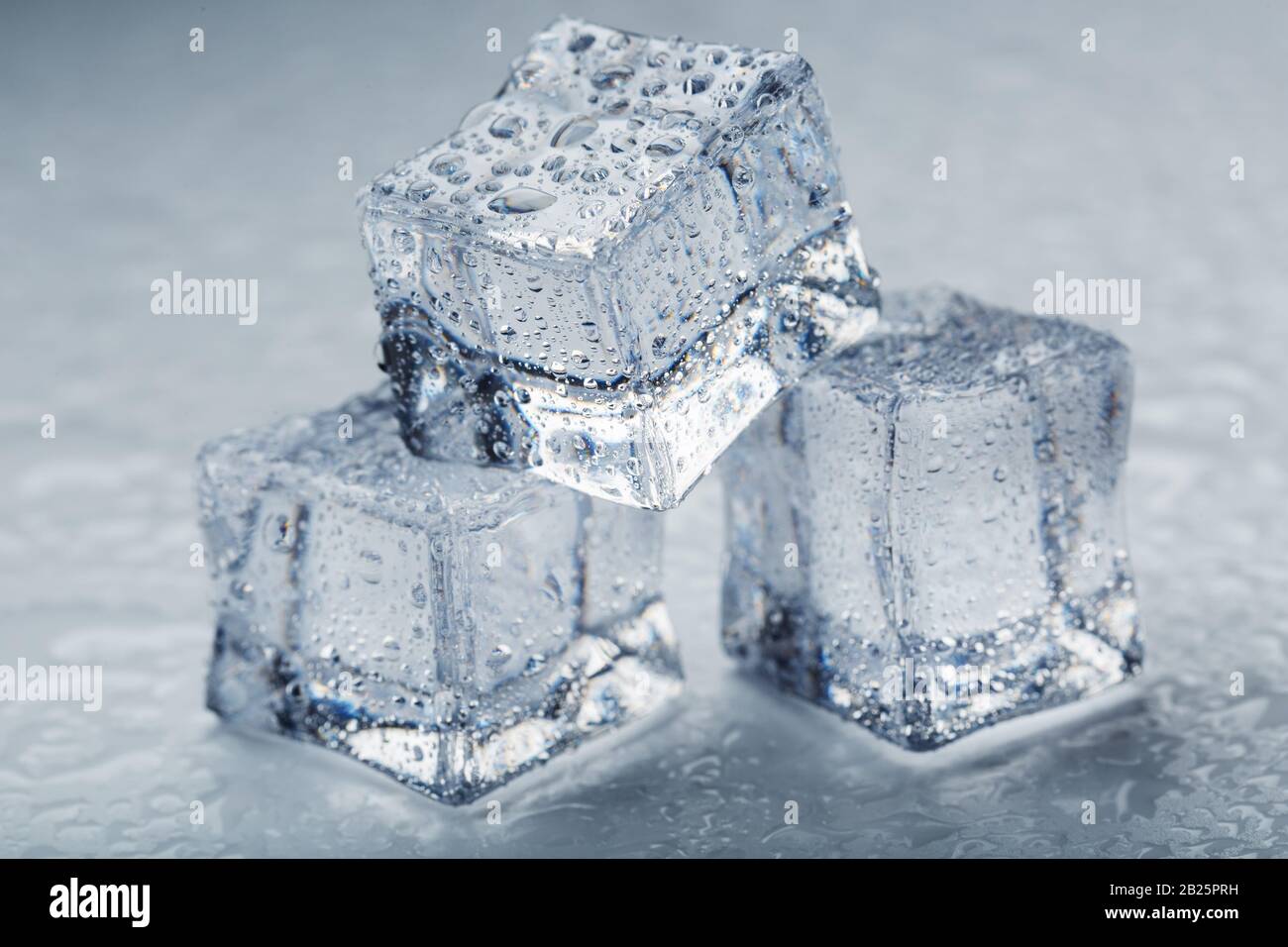 Ice cubes in the form of a pyramid with water drops close - up in macro ...