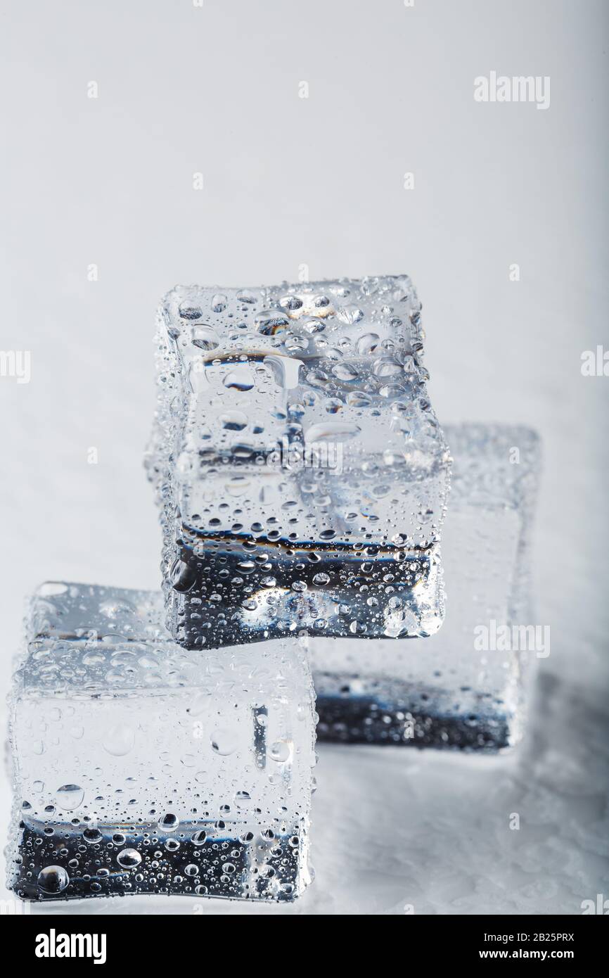 Ice cubes in the form of a pyramid with water drops close - up in macro ...
