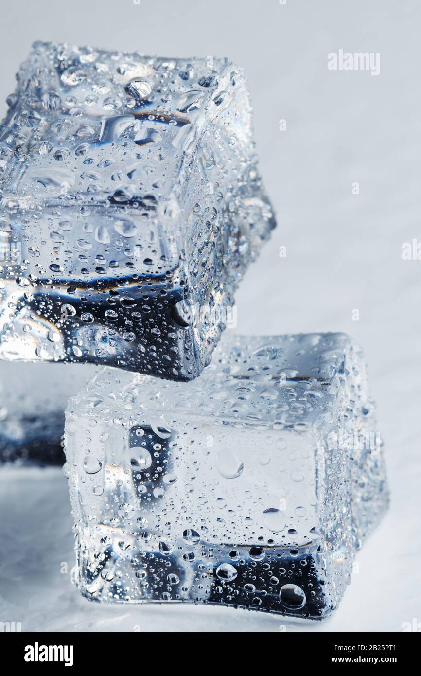 Ice cubes in the form of a pyramid with water drops close - up in macro ...