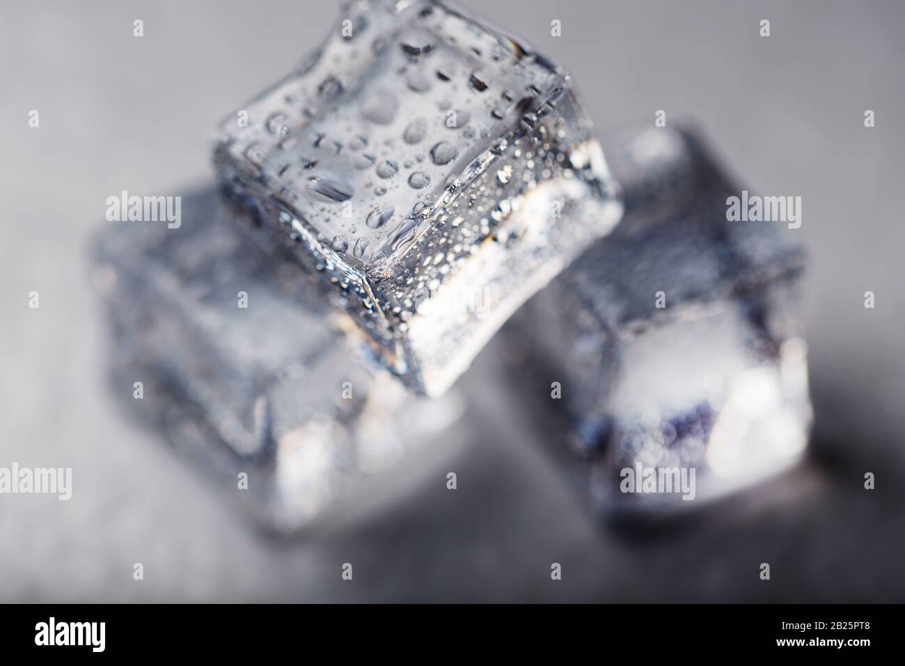 Ice cubes in the form of a pyramid with water drops close - up in macro ...