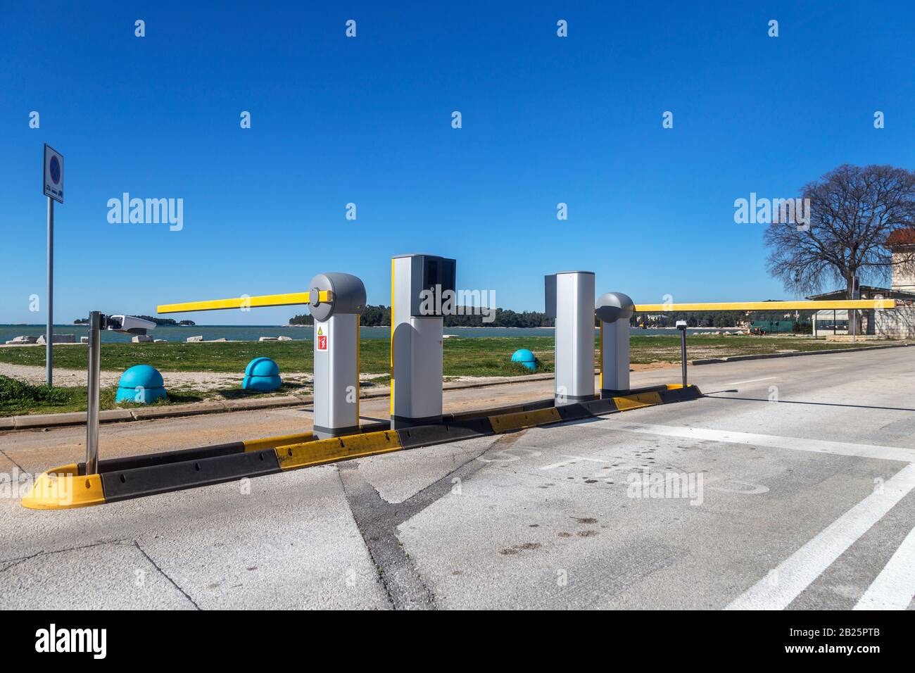 entrance and exit driveway with barrier to a parking lots Stock Photo ...