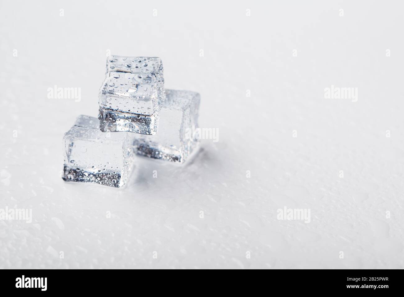 Ice cubes in the form of a pyramid with water drops close - up in macro ...