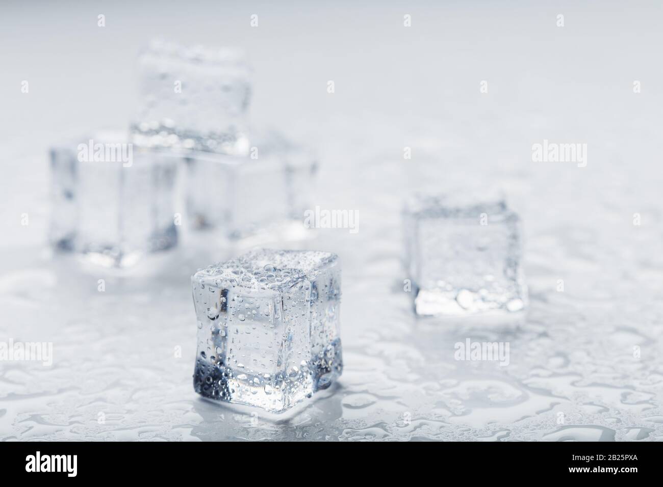 Ice cubes in the form of a pyramid with water drops close - up in macro ...