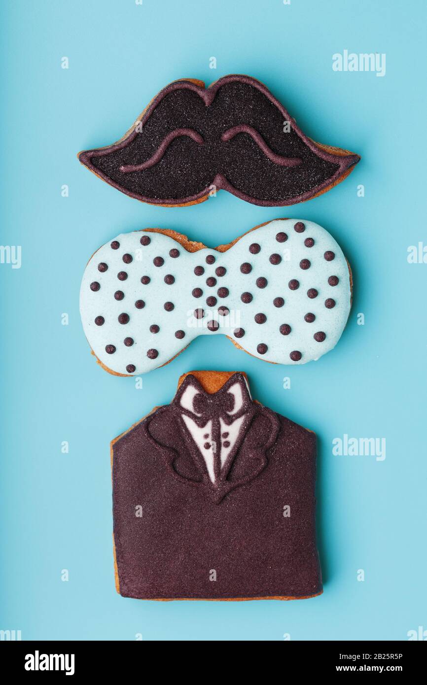 Glazed gingerbread in the form of a mustache, butterfly and tuxedo, men ...