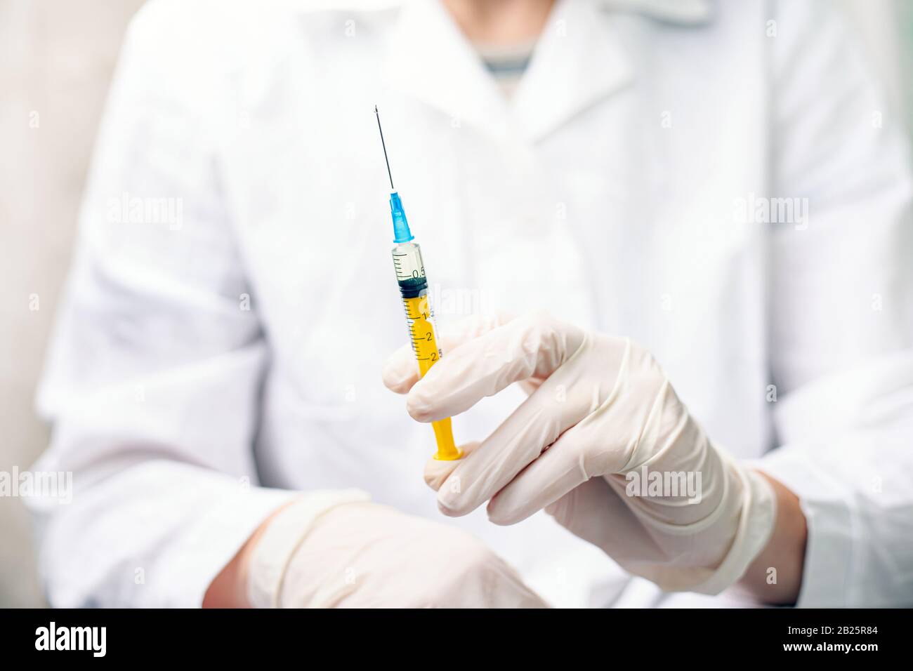 doctor holds a syringe with medicine. Concept: vaccine for virus ...