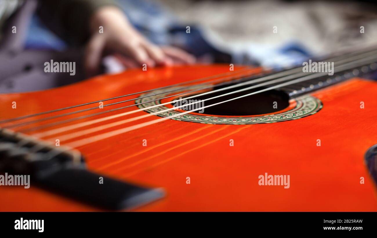 children learning to play a musical instrument acoustic guitar Stock ...