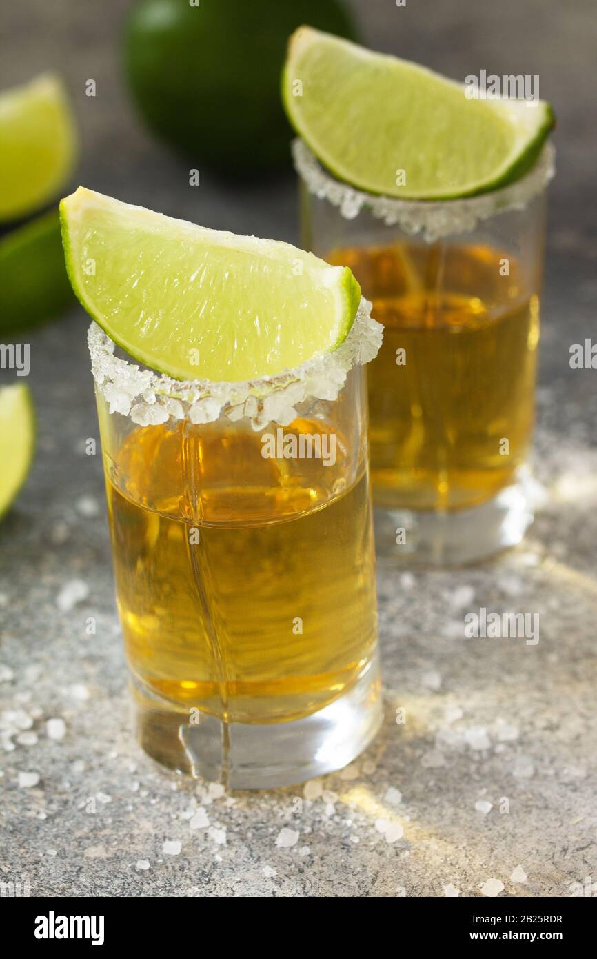 Gold Tequila close-up. Mexican Gold Tequila shot with lime and salt on ...