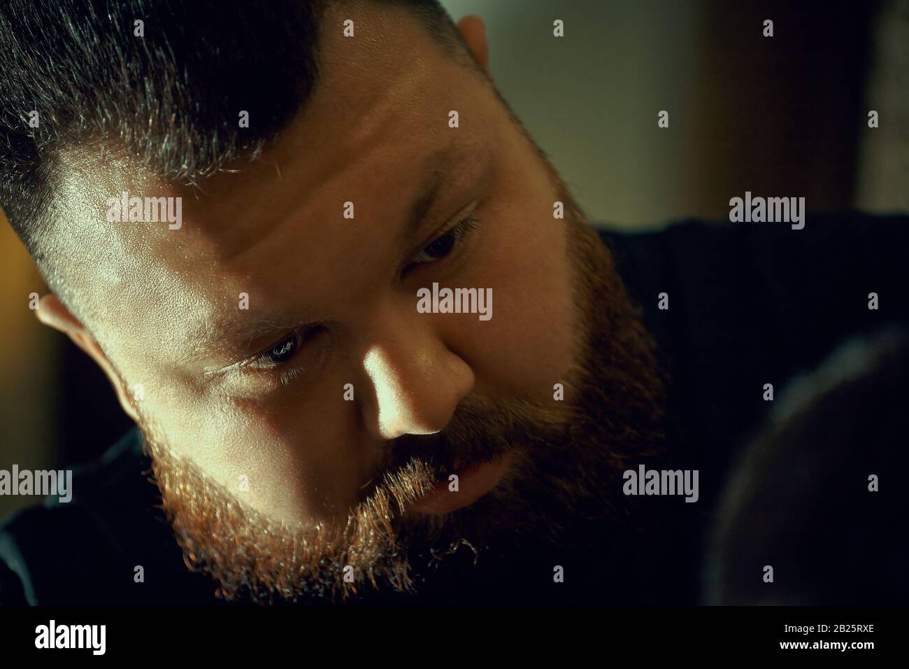 Close-up portrait of Barber doing the hairstyle and styling to his ...