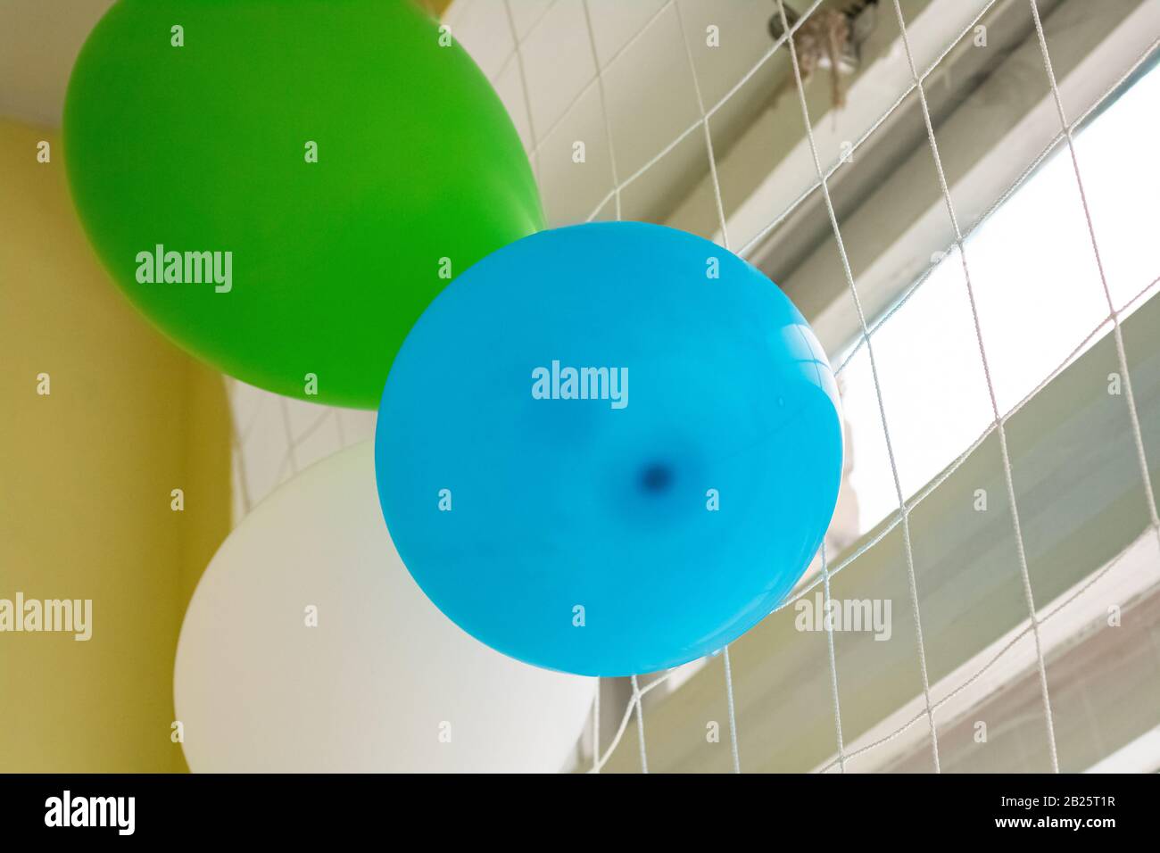 Colorful balloons on the window close up Stock Photo - Alamy