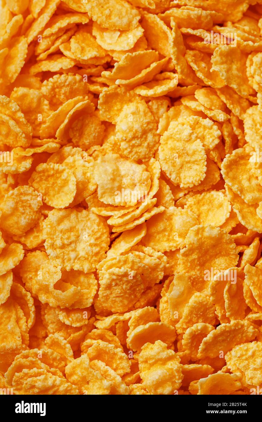 Golden cornflakes background and texture. View from above. cornflakes ...