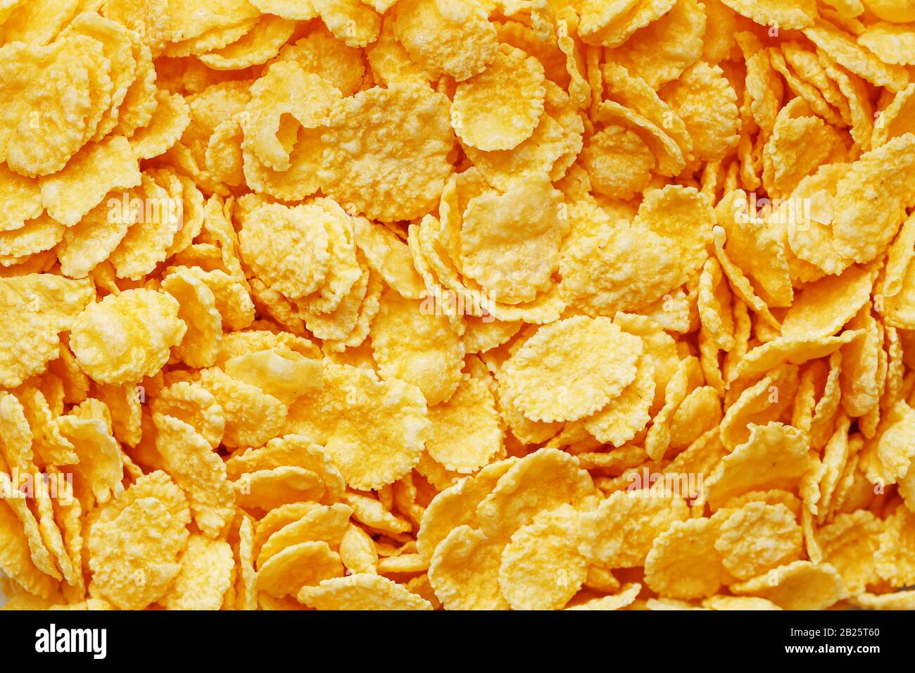 Golden cornflakes background and texture. View from above. cornflakes ...