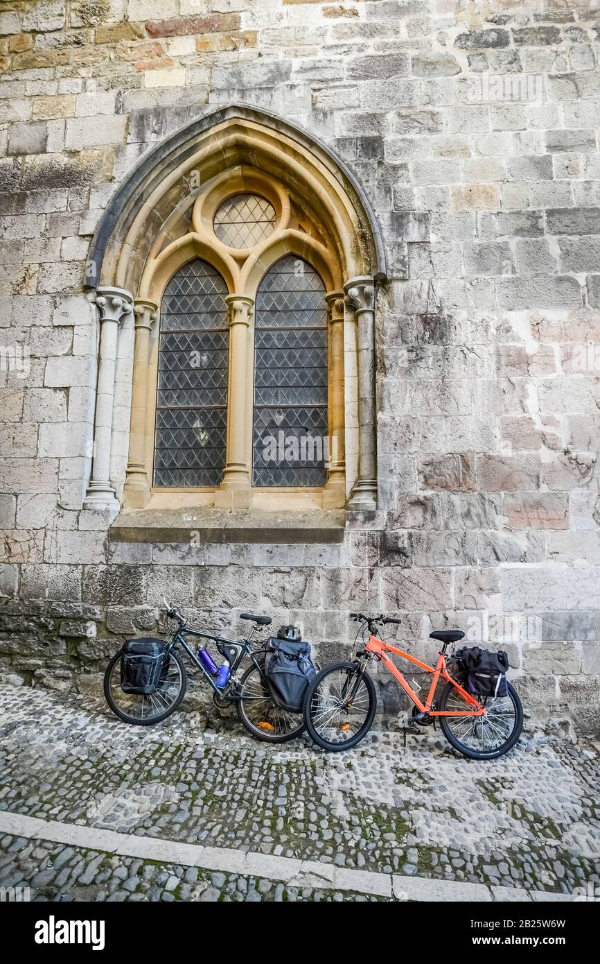 two bikes with saddlebags of pilgrims leaning on the facade of the ...