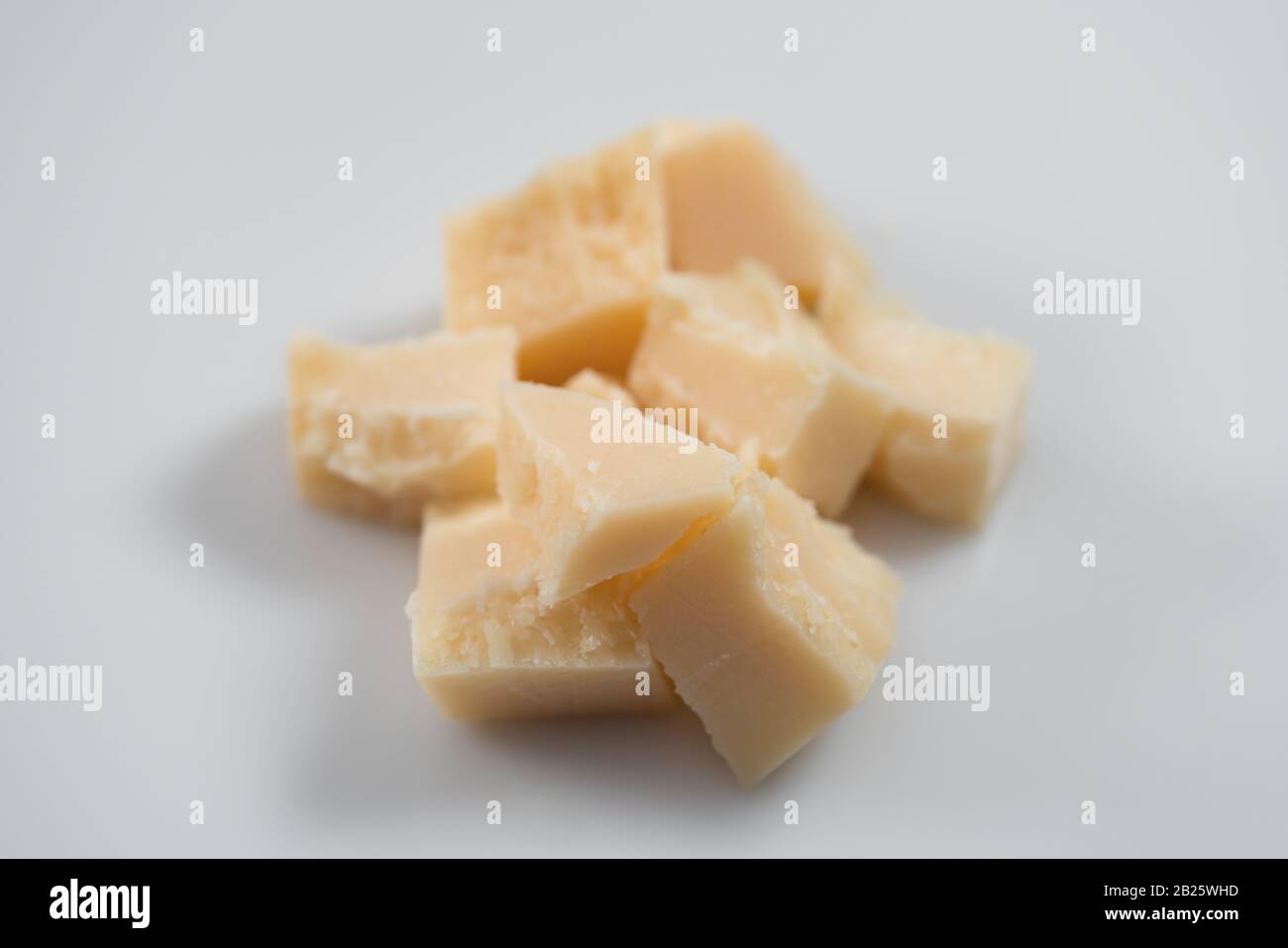 Parmesan cheese chunks on white background, shallow focus Stock Photo ...