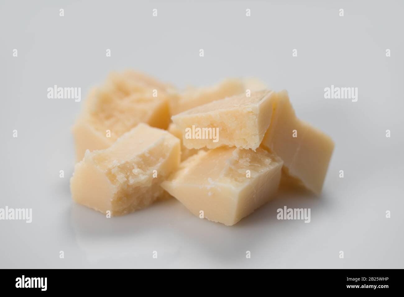 Parmesan cheese chunks on white background, shallow focus Stock Photo ...