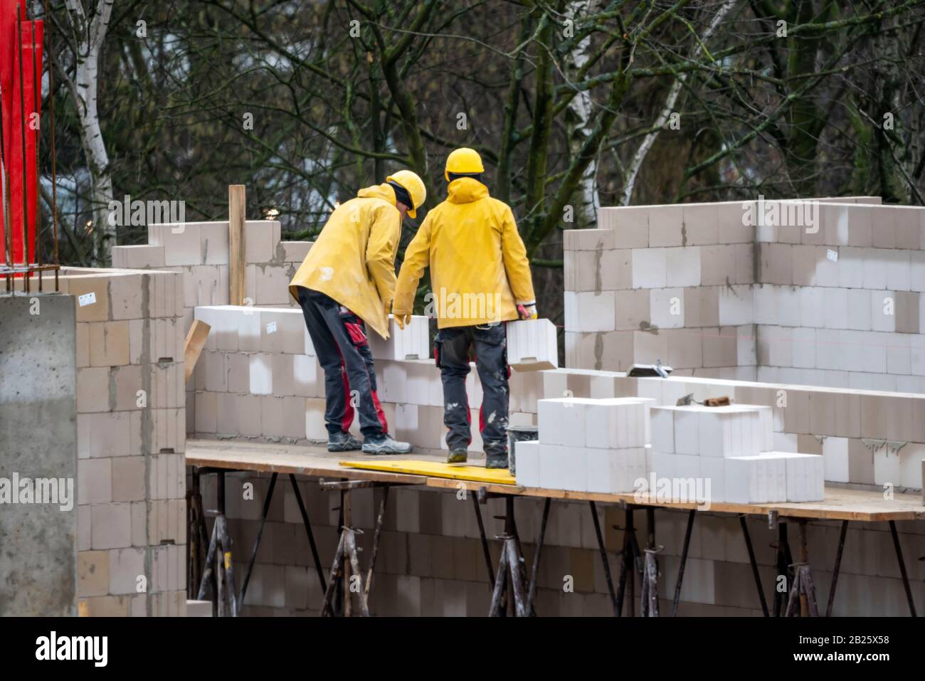 Construction site, residential house is being built, masons at work ...