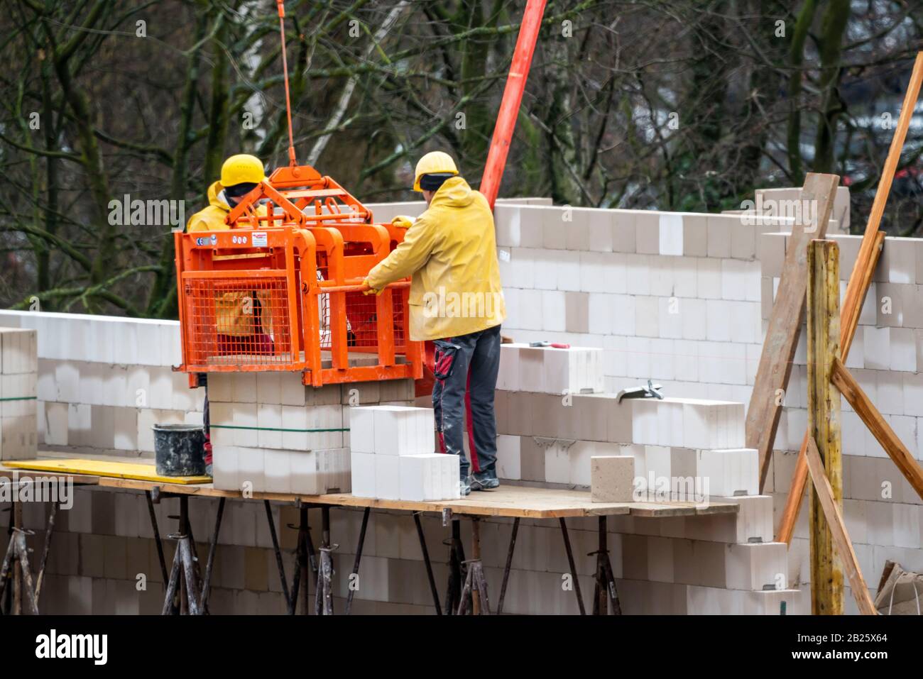 Construction site, residential house is being built, masons at work ...