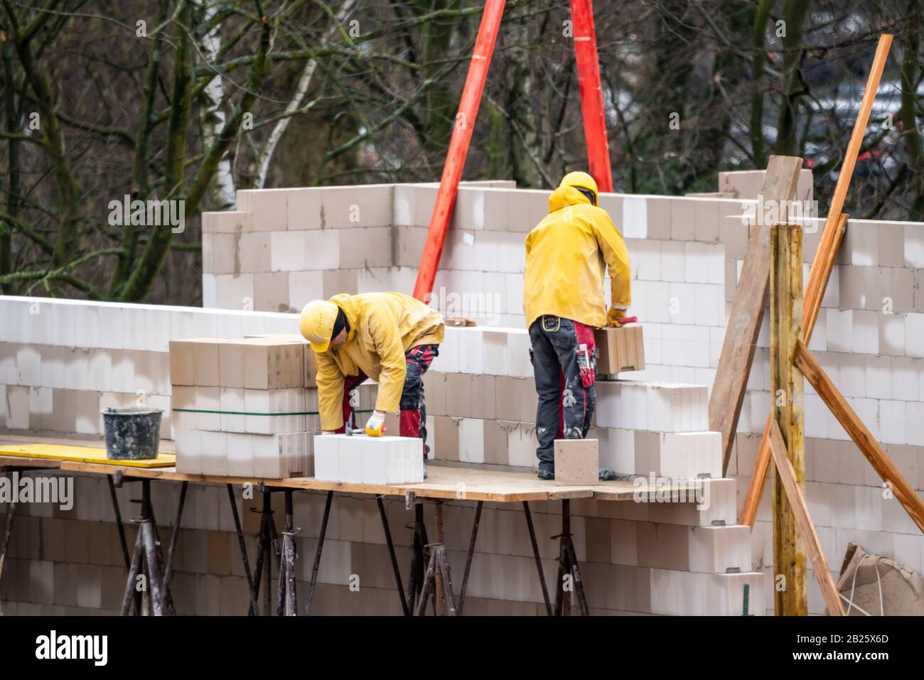 Construction site, residential house is being built, masons at work ...
