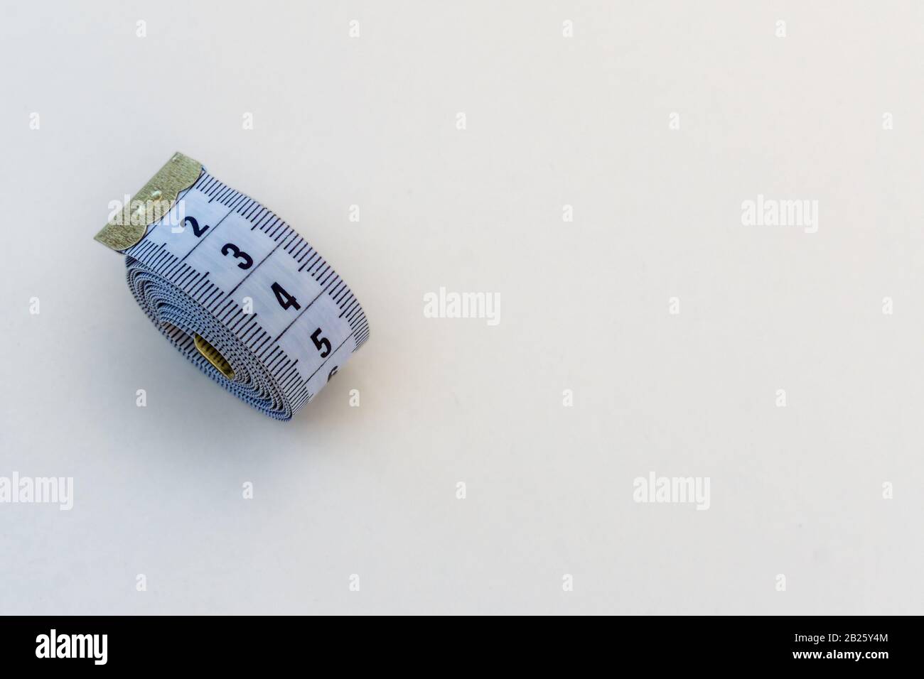 white measuring tape isolated on white background Stock Photo - Alamy