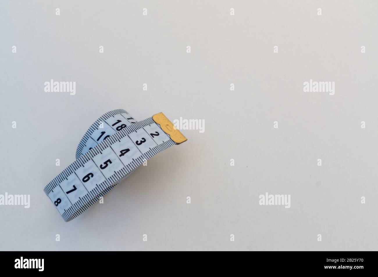 white measuring tape isolated on white background Stock Photo - Alamy