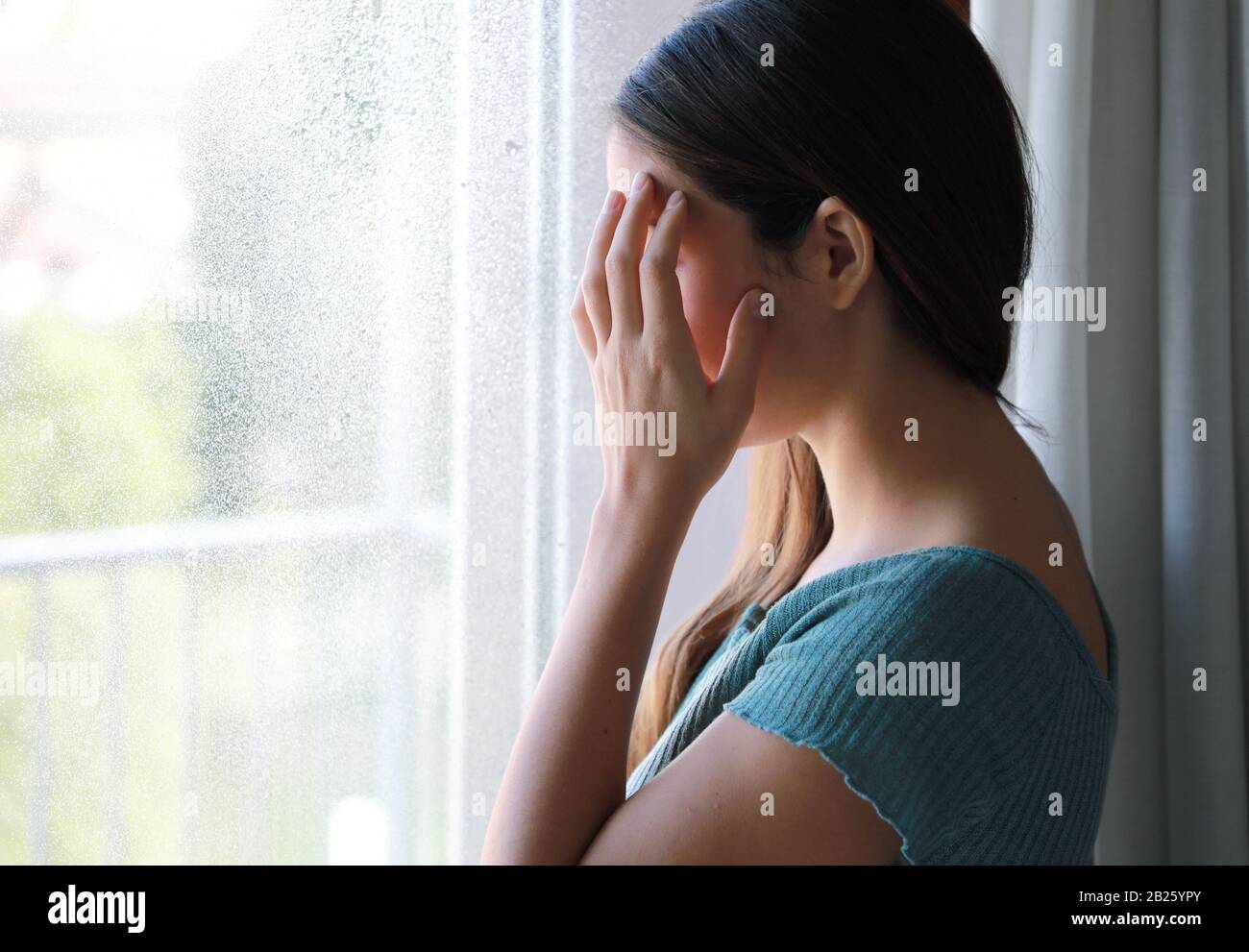 Seasonal affective disorder concept. Sad depressed girl crying near the ...