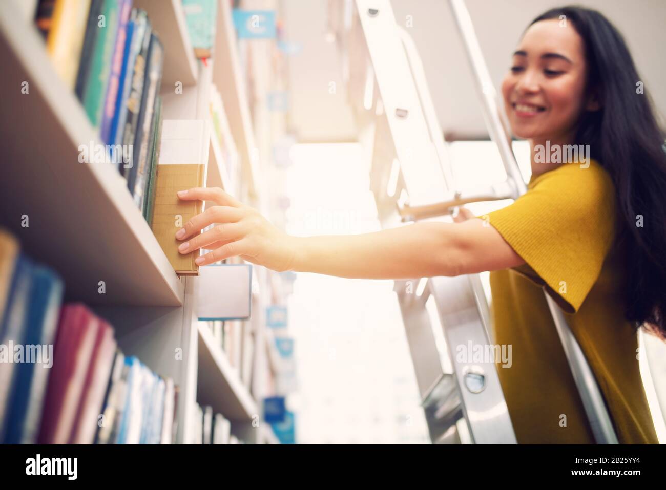 Girl choose a book to read. Concept of culture and studying Stock Photo ...