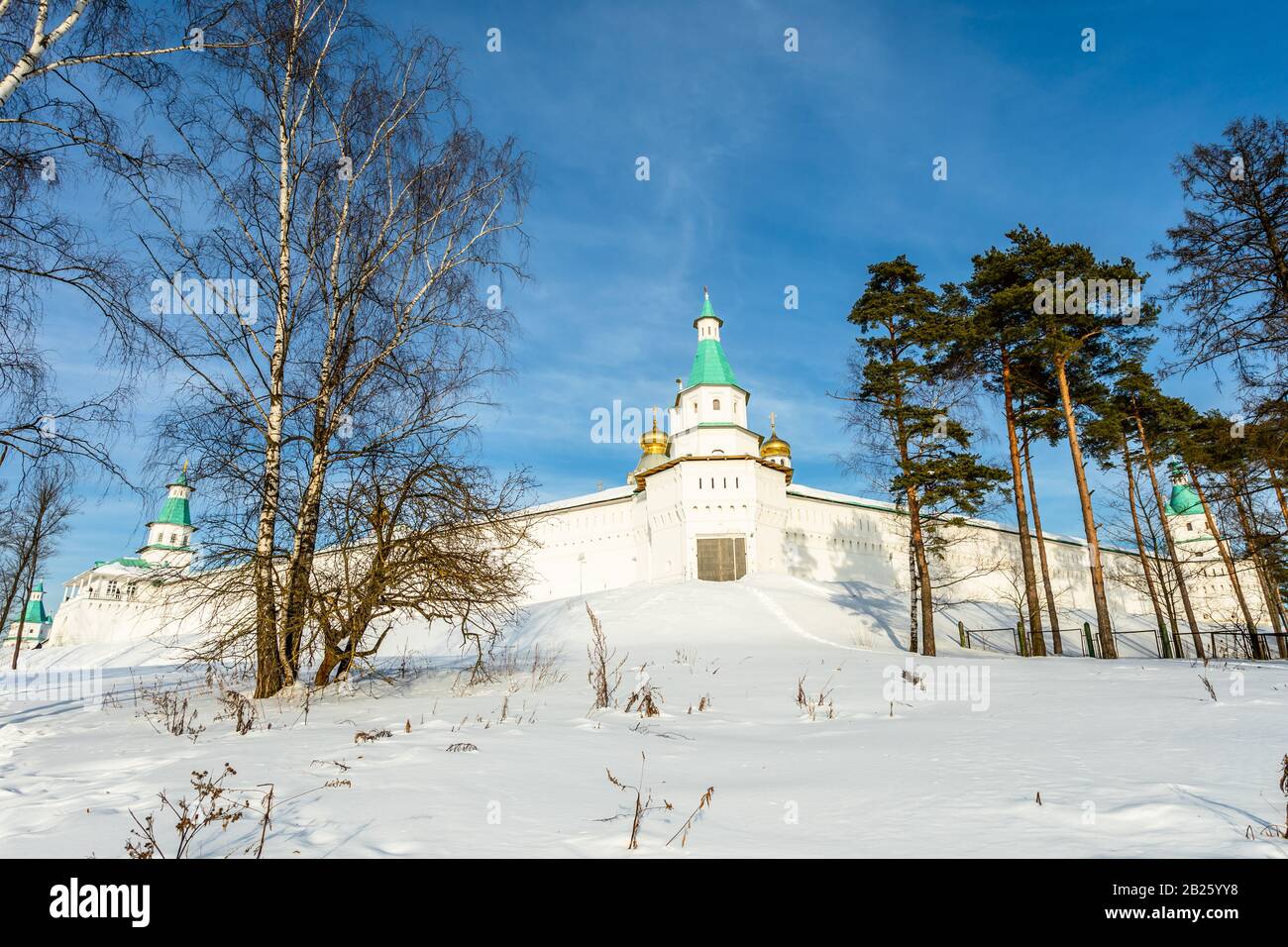 Snow and white walls, golden domes and a tower gate of New Jerusalem ...