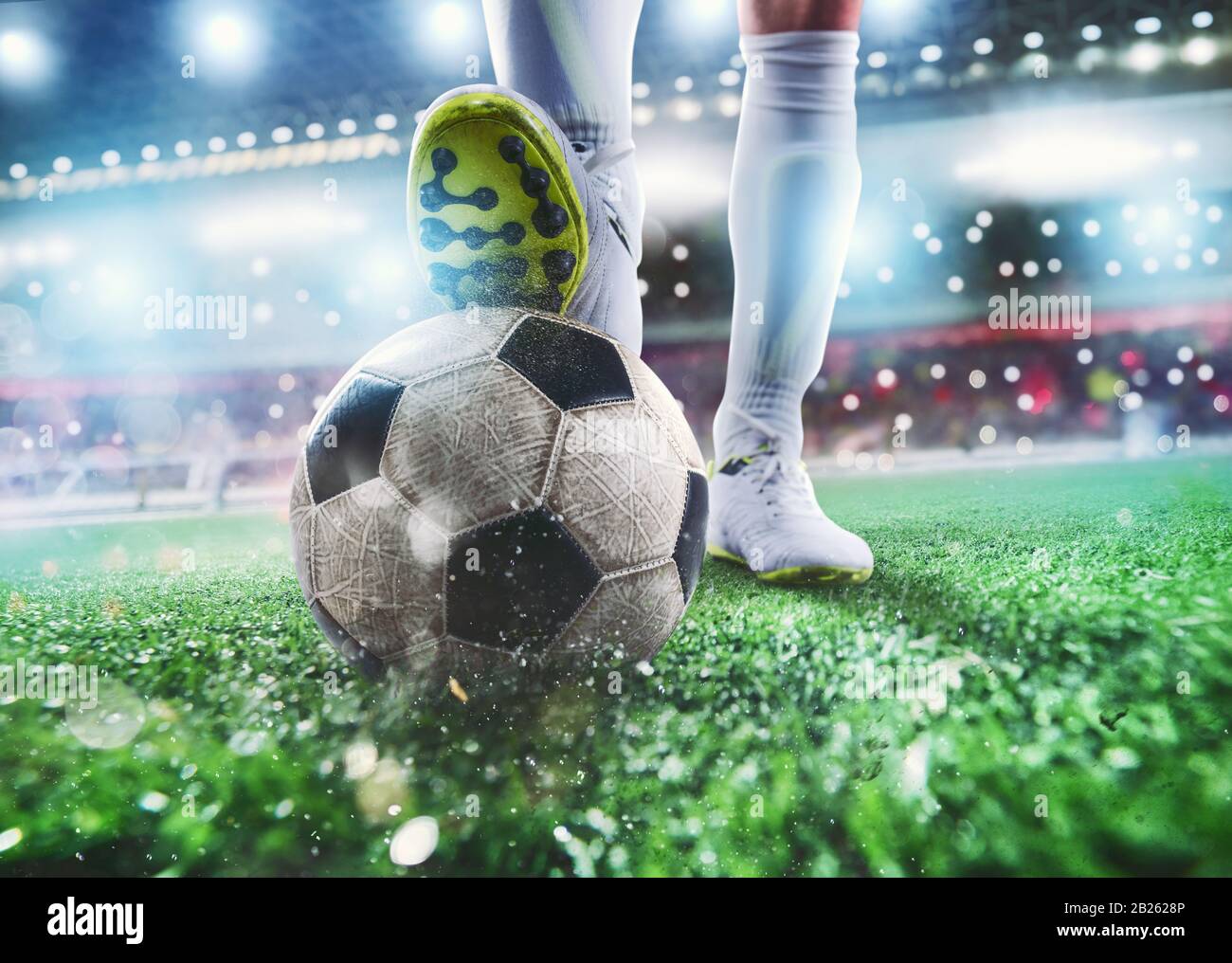 Close up of a soccer striker ready to kicks the ball at the stadium ...