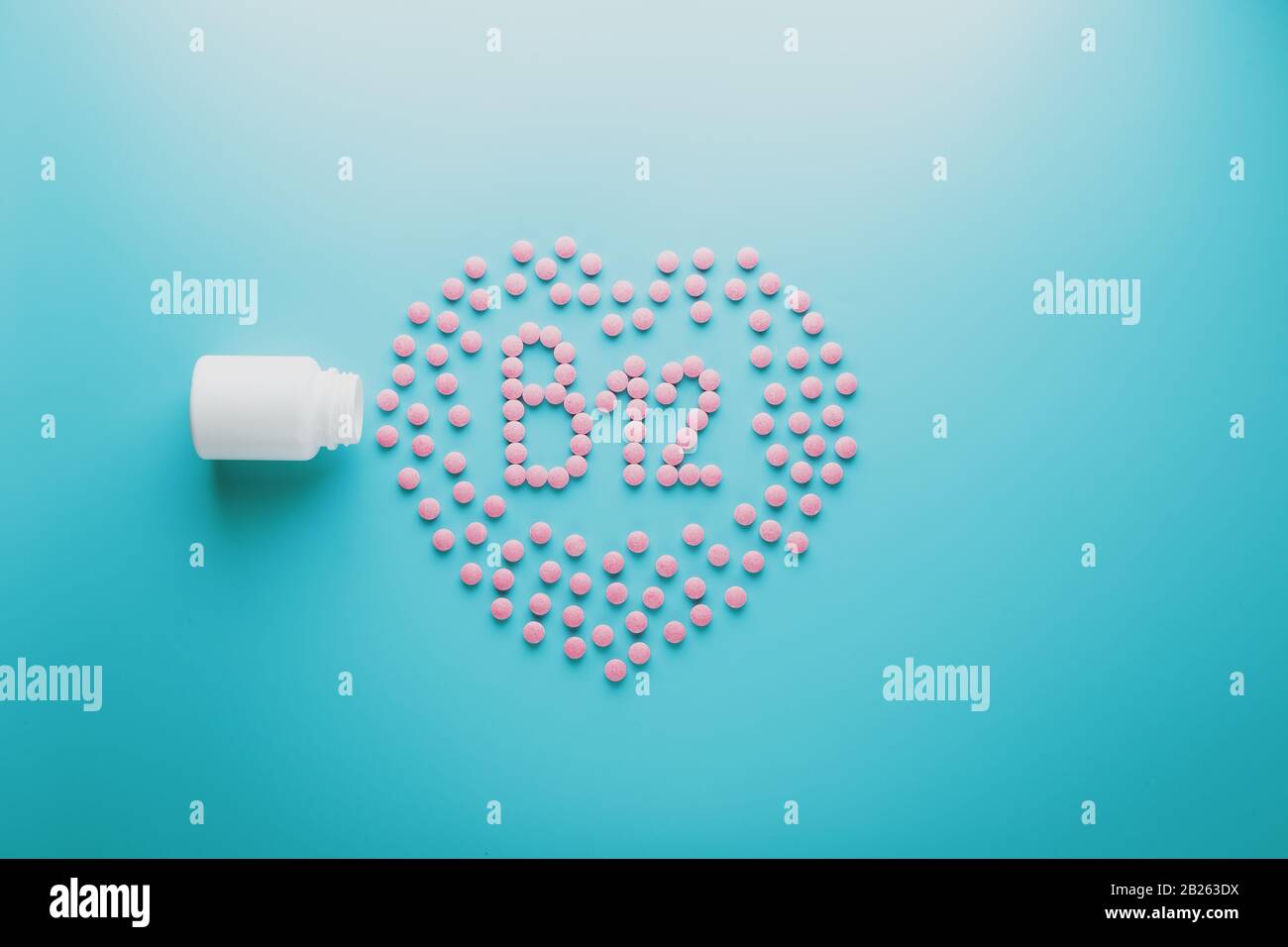 Pink tablets in the form of B12 in the heart on a blue background ...