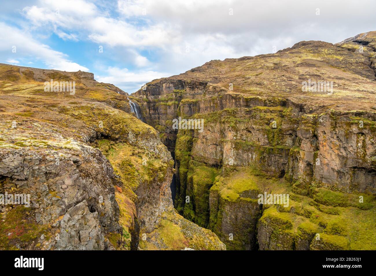 Glymur waterfall in Iceland gorge behind fall overgrown green cliffs ...