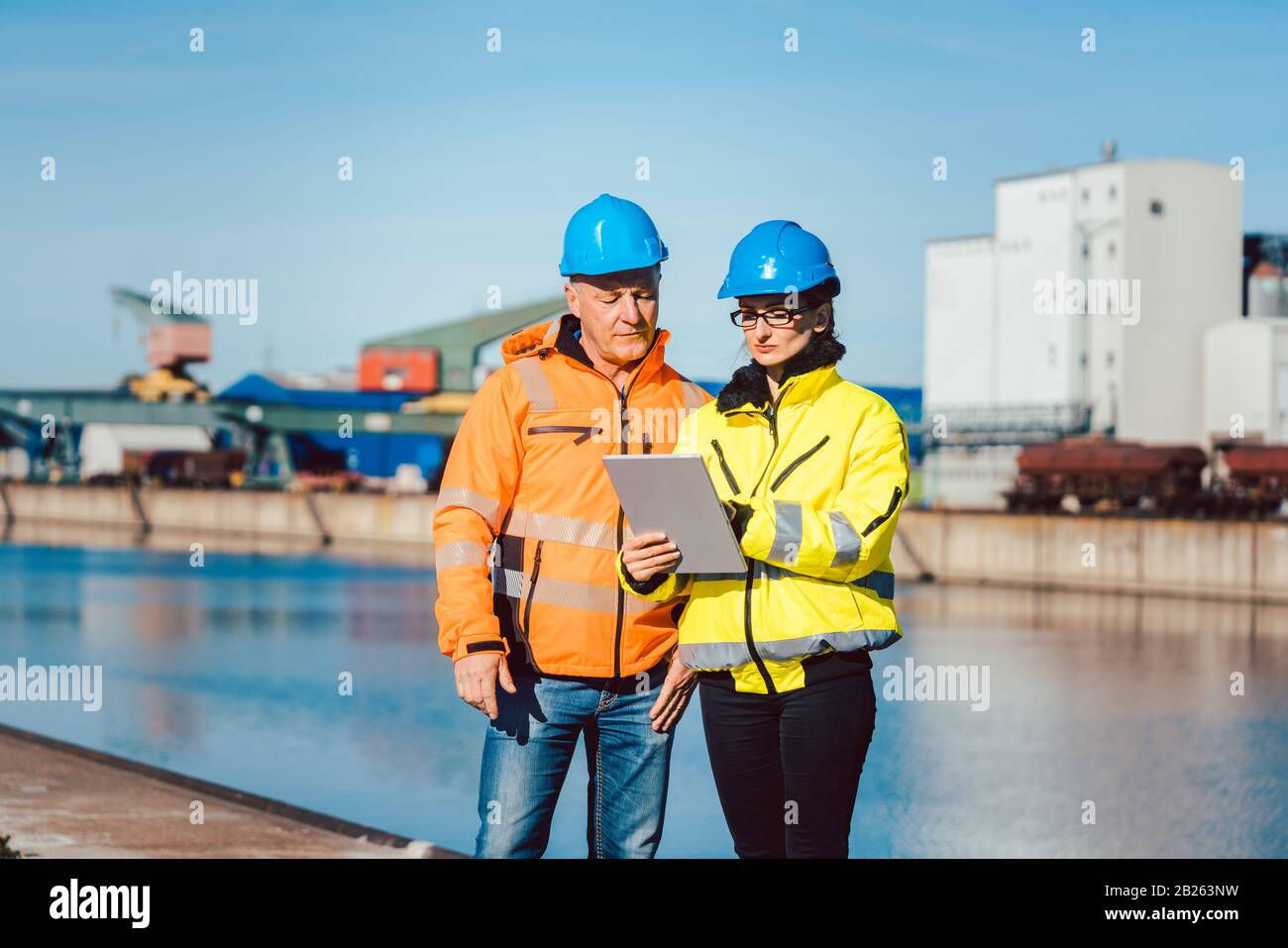 Workers waiting for a delivery at commercial river port Stock Photo - Alamy