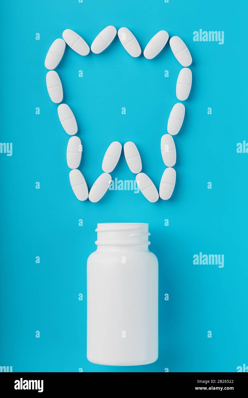 Vitamins with calcium Ca in the form of a tooth are scattered from a ...