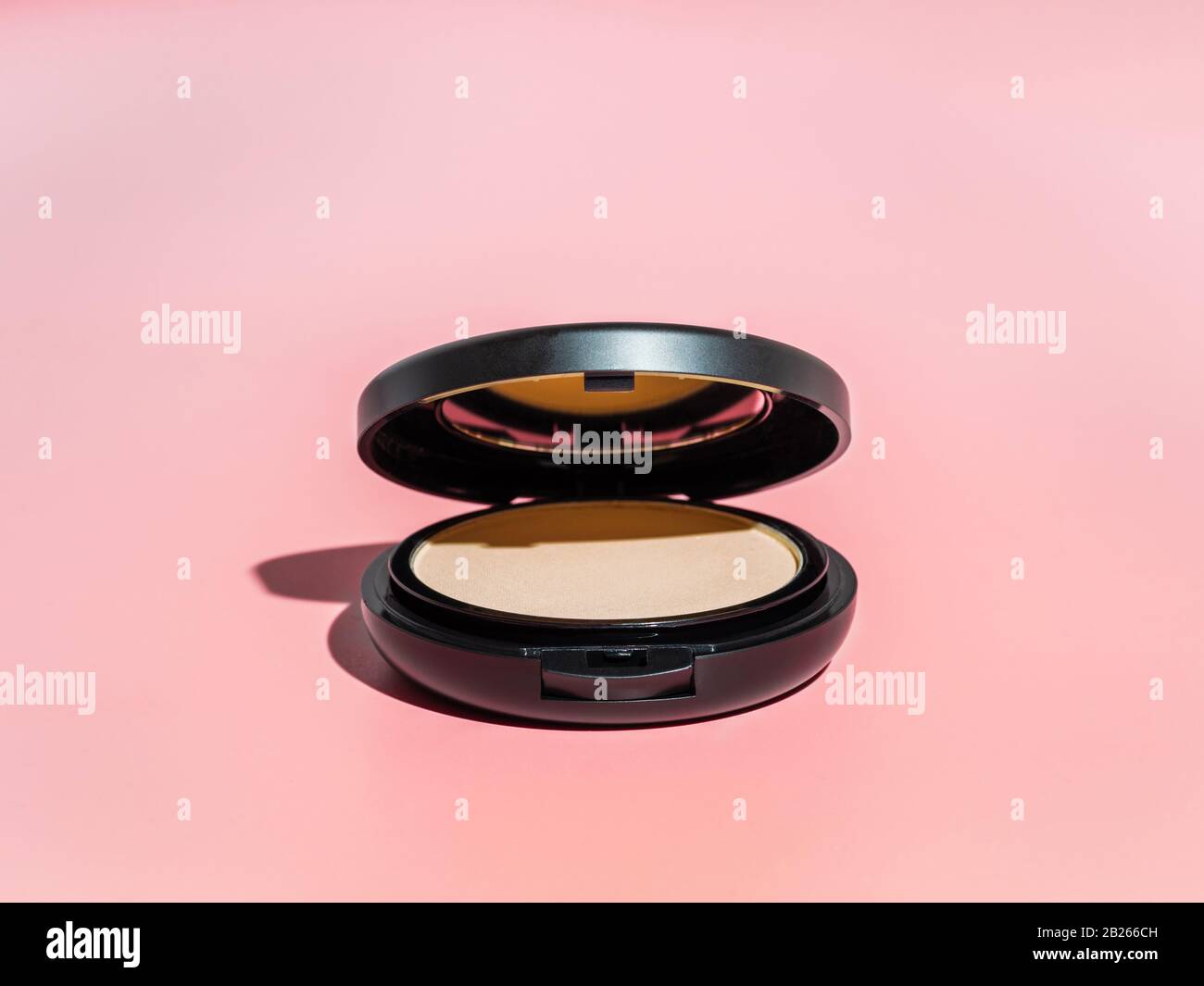 Compact powder on pink background. Female pressed powder in ajar opened ...