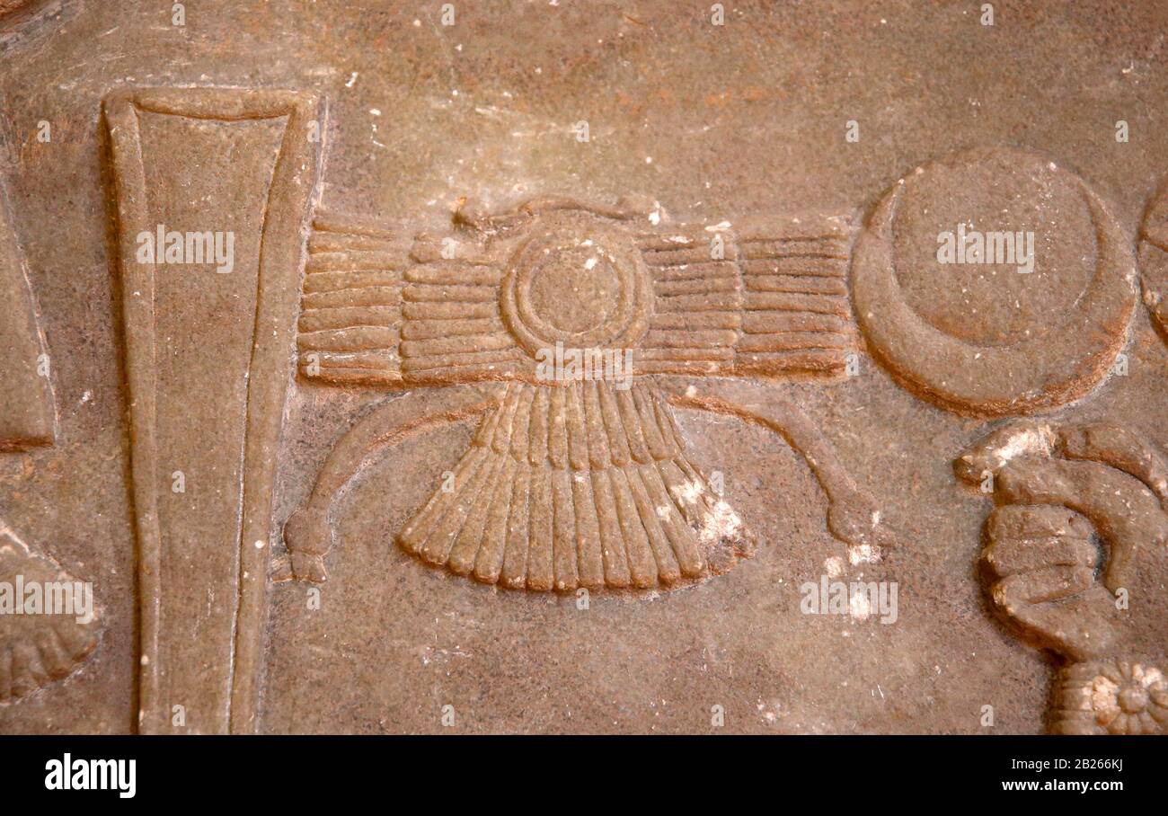 Bel-harran-beli-usur is praying in front of divine symbols. Stele with ...