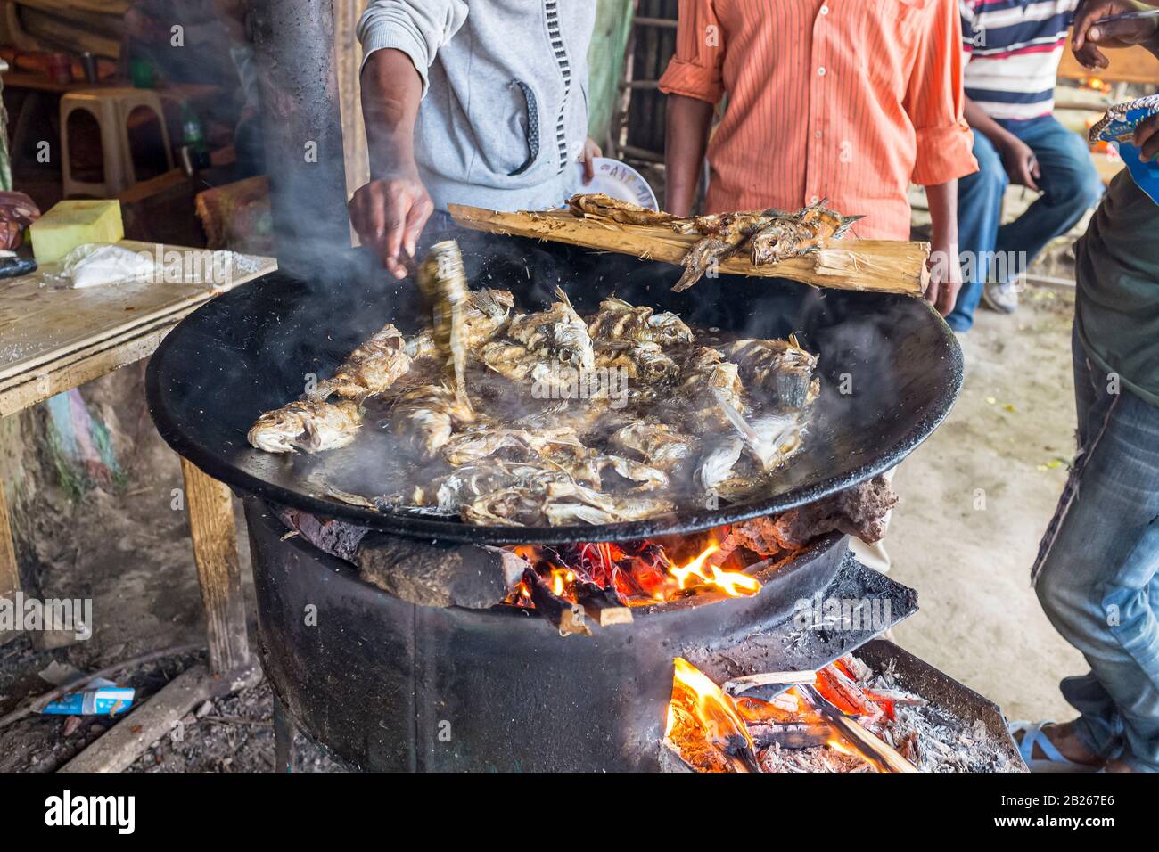 Cooking fish in a pan over an open fire at Awasa Fish Market, Lake ...