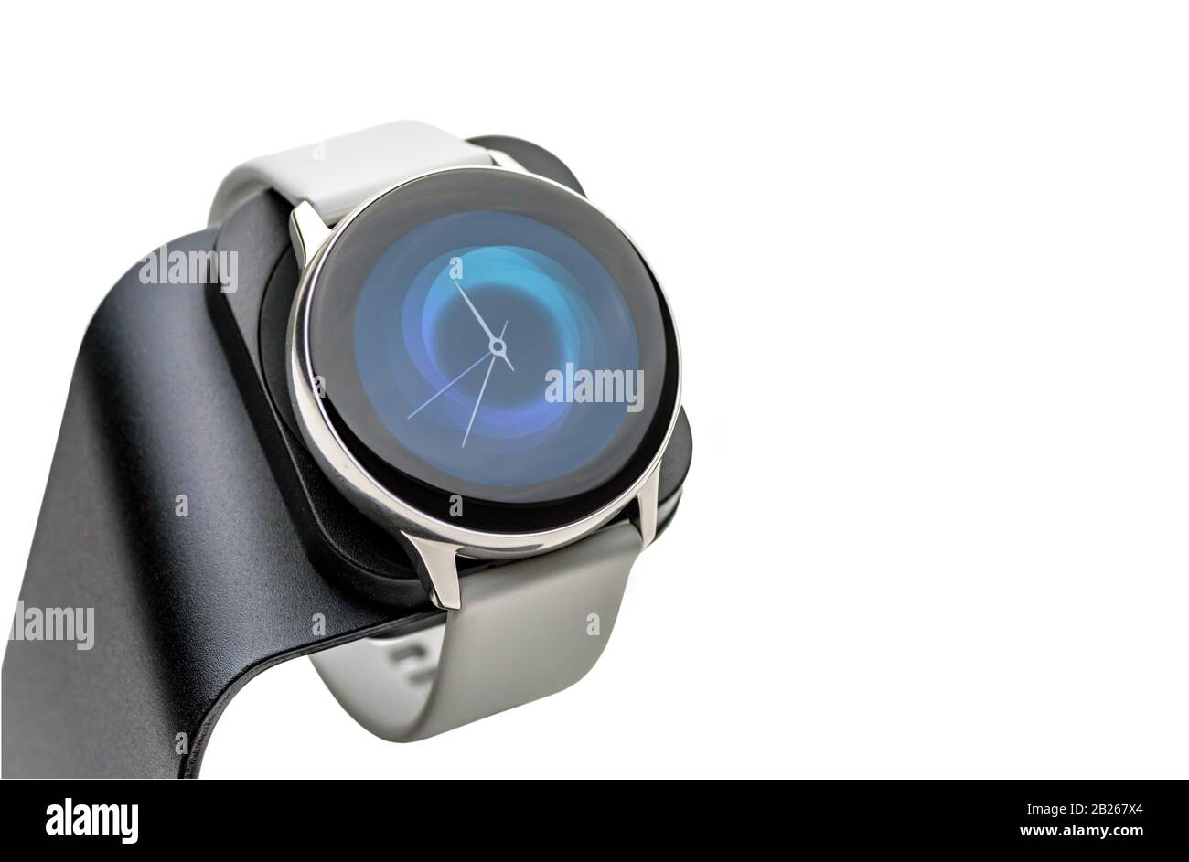 smart watch charging on wireless charging stand pad on white background ...