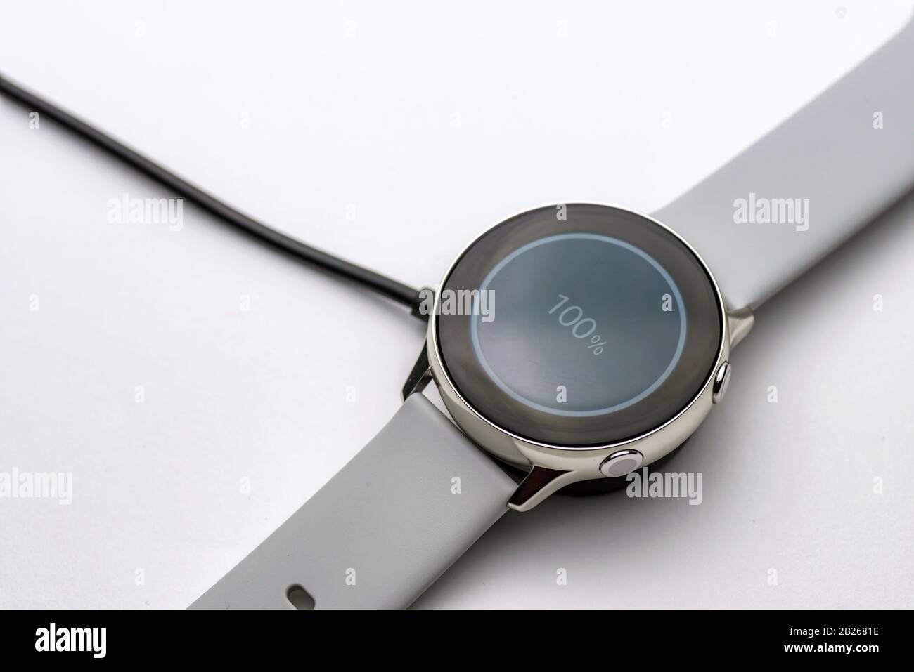 smart watch wireless charging on charging pad on kitchen worktop table ...